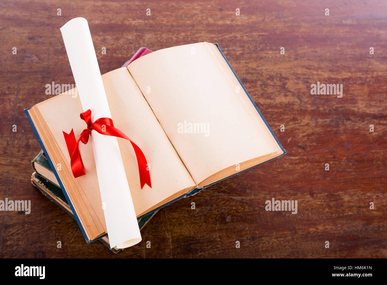 Diploma with old book Stock Photo - Alamy