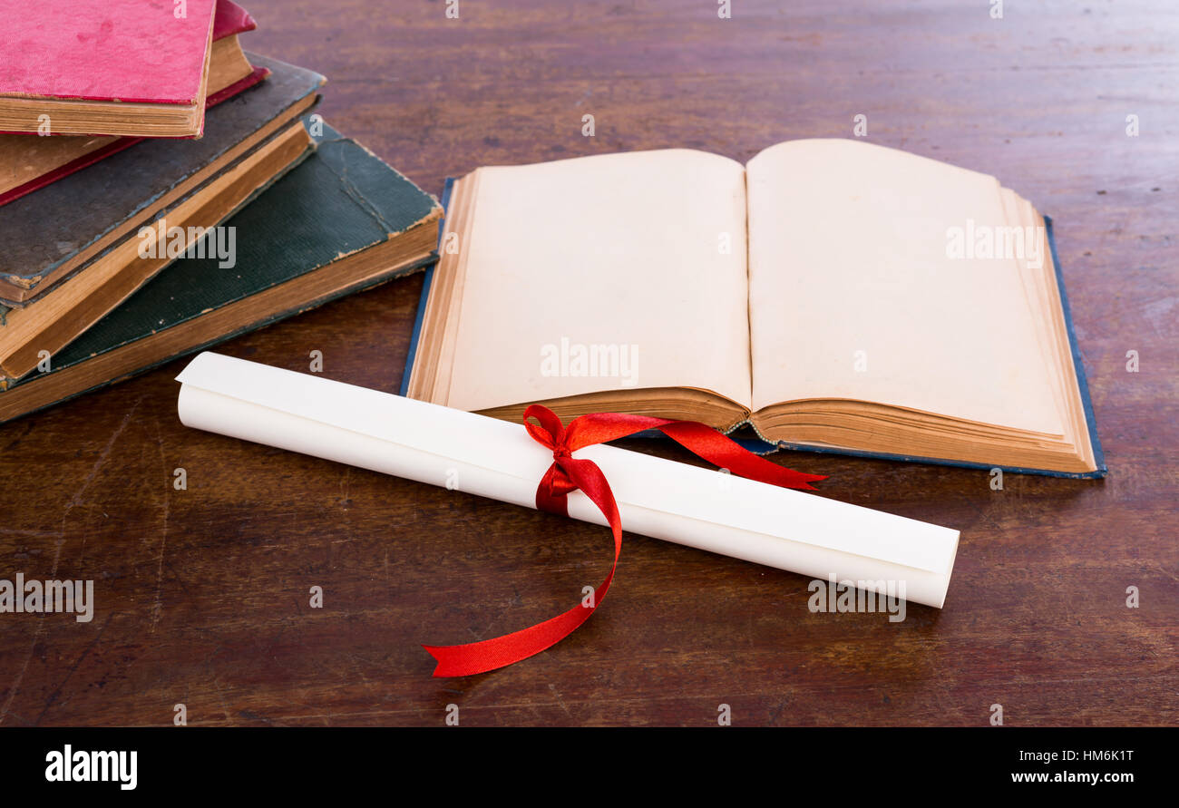 Diploma with old book Stock Photo - Alamy