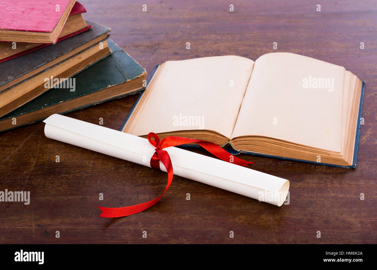 Diploma with old book Stock Photo - Alamy