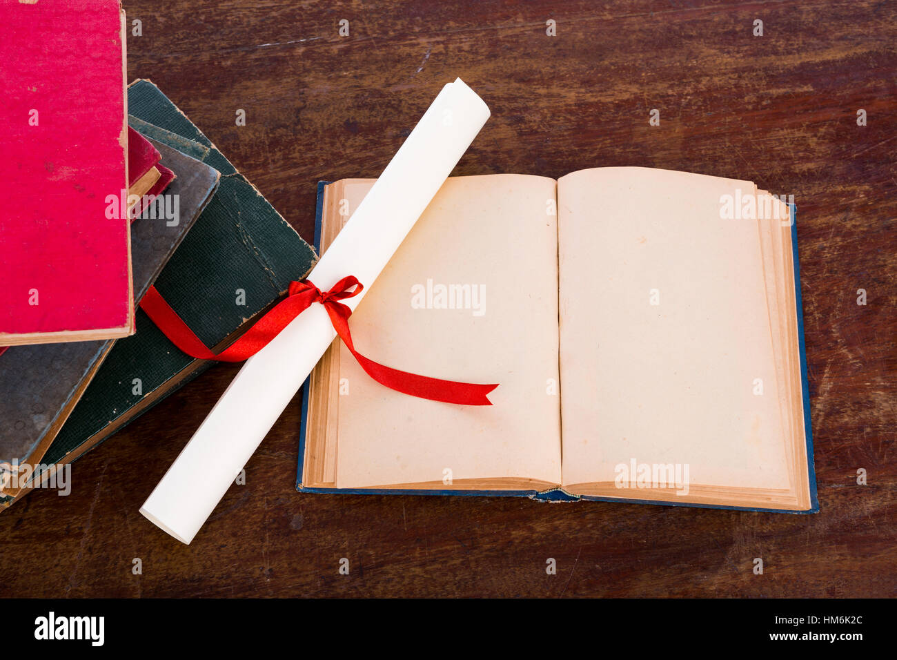 Diploma with old book Stock Photo - Alamy