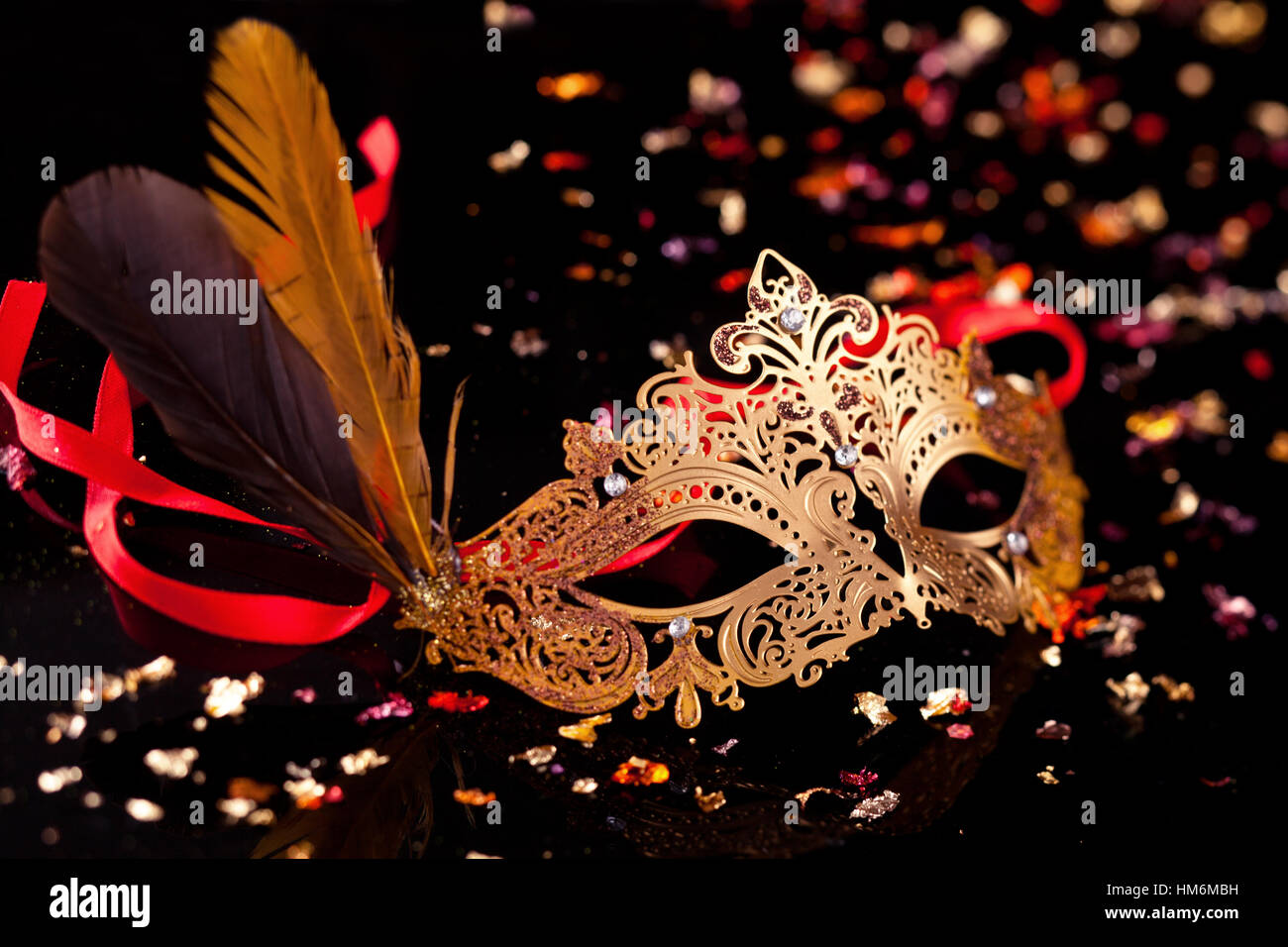 Gold carnival mask on black background Stock Photo - Alamy