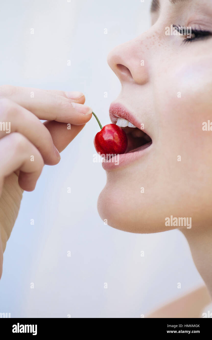 young woman eat cherries Stock Photo - Alamy