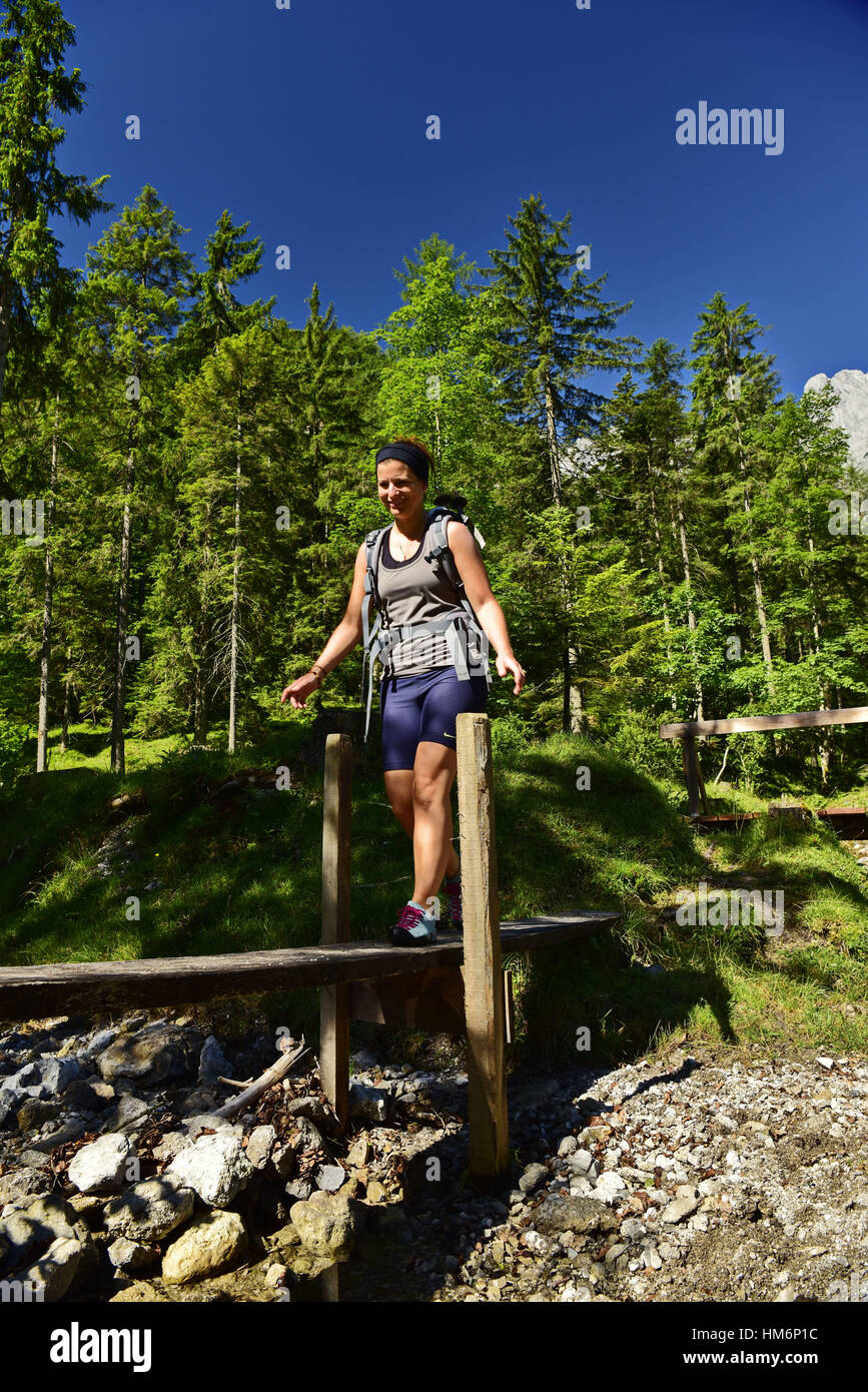 Young woman walking over a bridge Stock Photo - Alamy