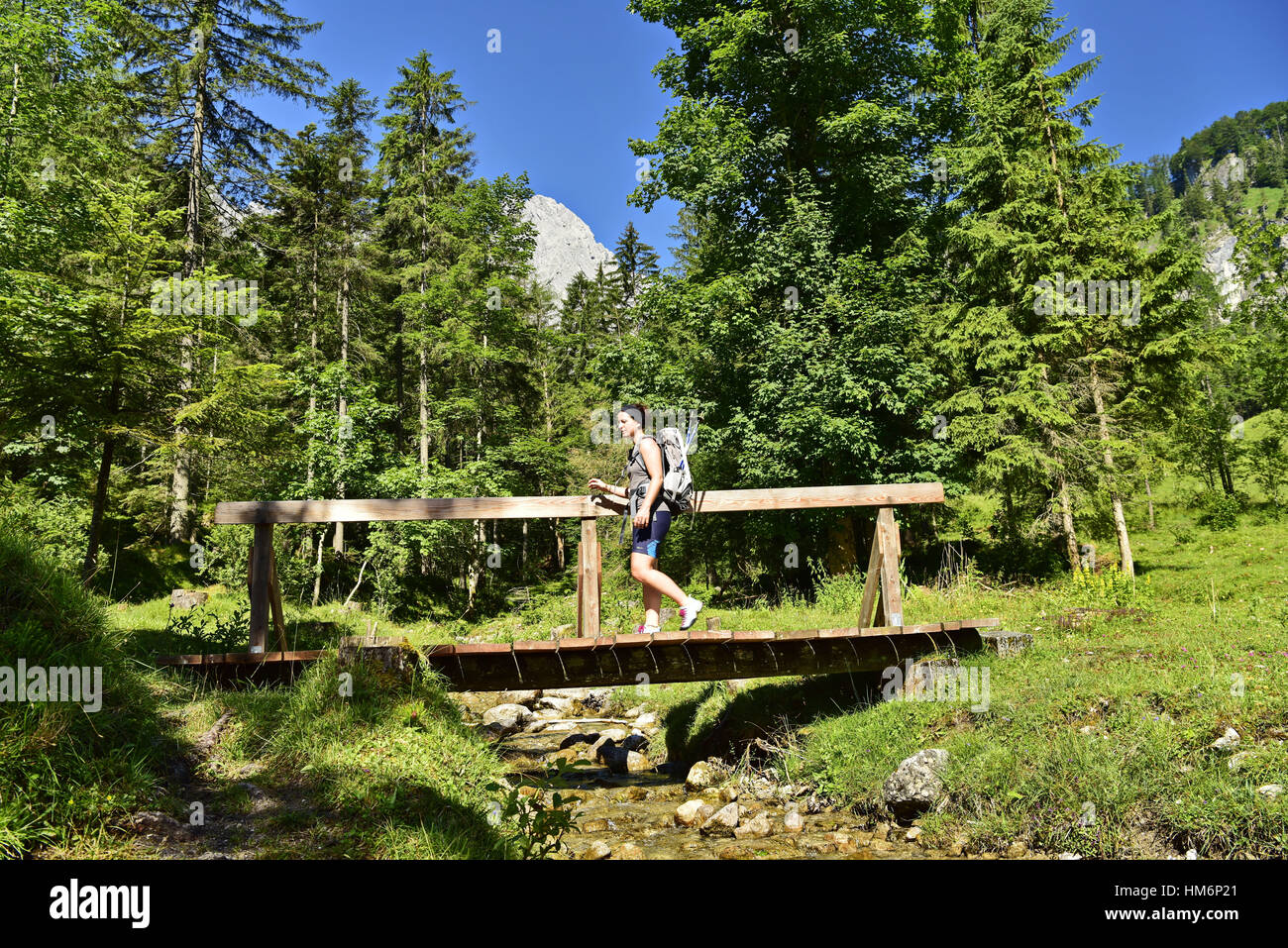 Young woman walking over a bridge Stock Photo - Alamy