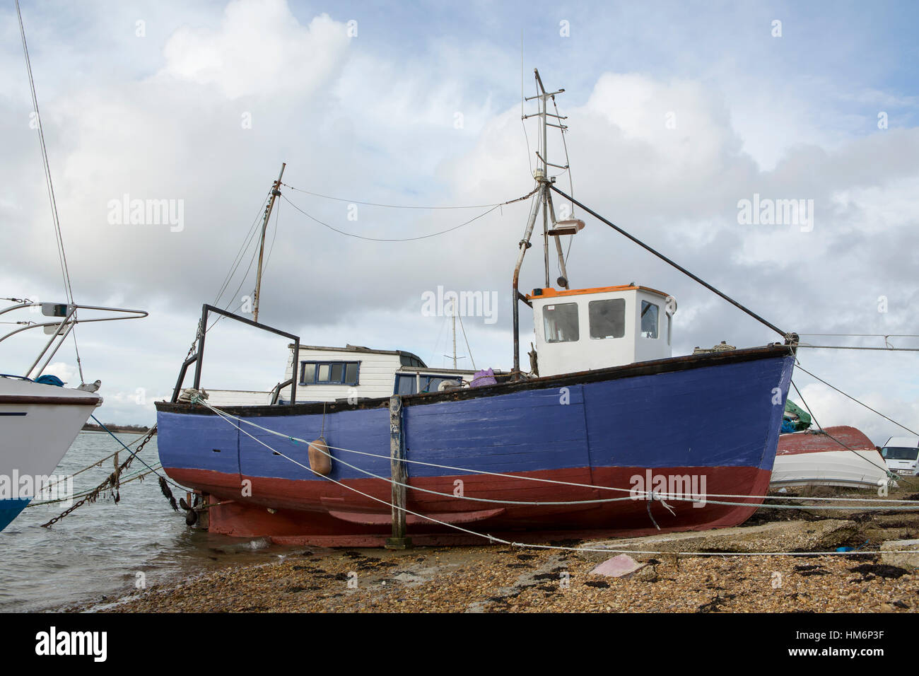 Old beached fishing boat in Portsmouth harbour. Low angle on a fine day ...