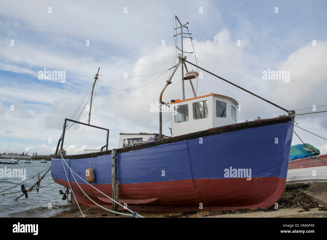 Old beached fishing boat in Portsmouth harbour. Low angle on a fine day ...