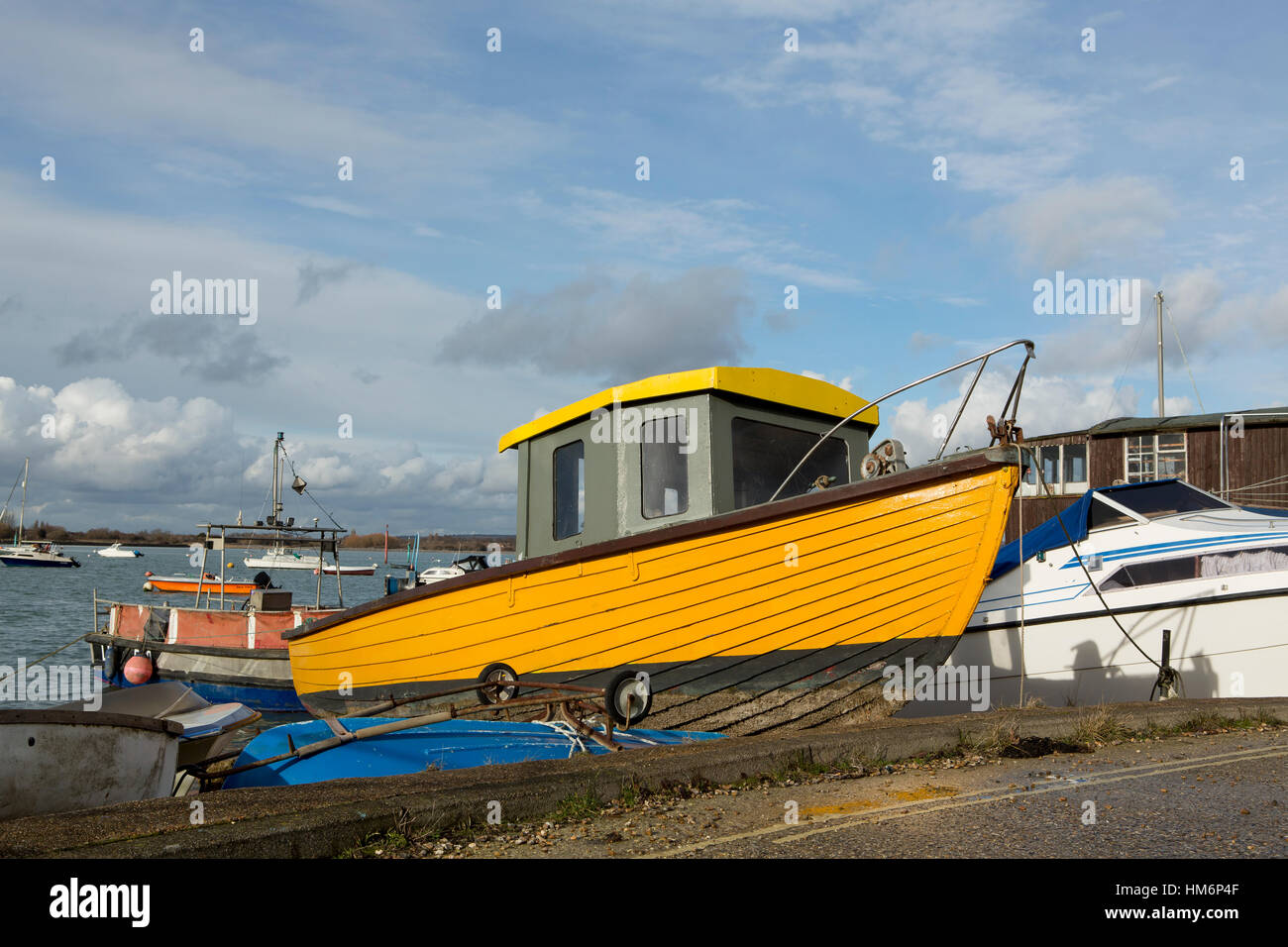 Old beached wooden fishing boat in Portsmouth harbour. Low angle on a ...