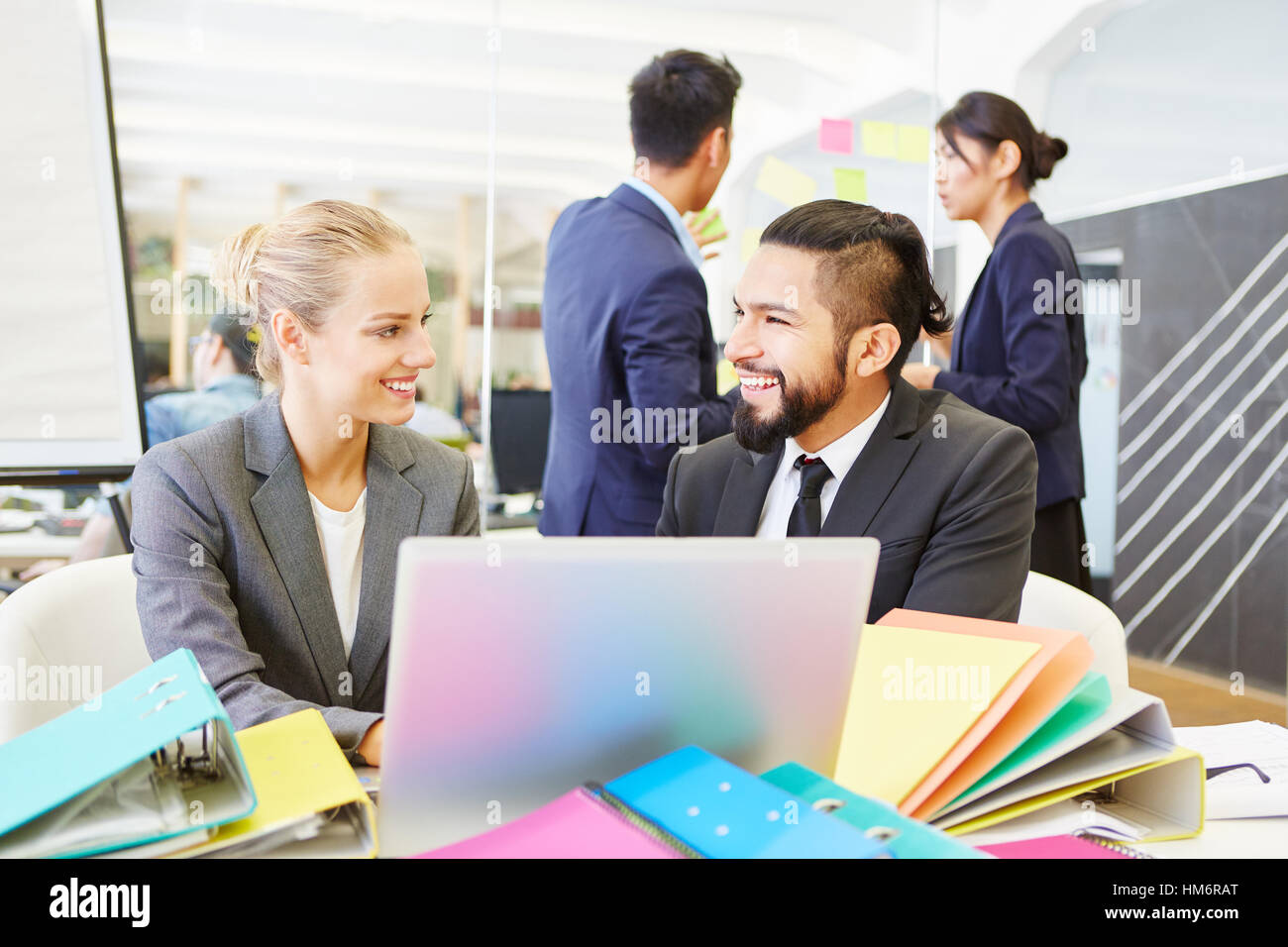 Founders team working with joy in cooperation for successful workshop ...