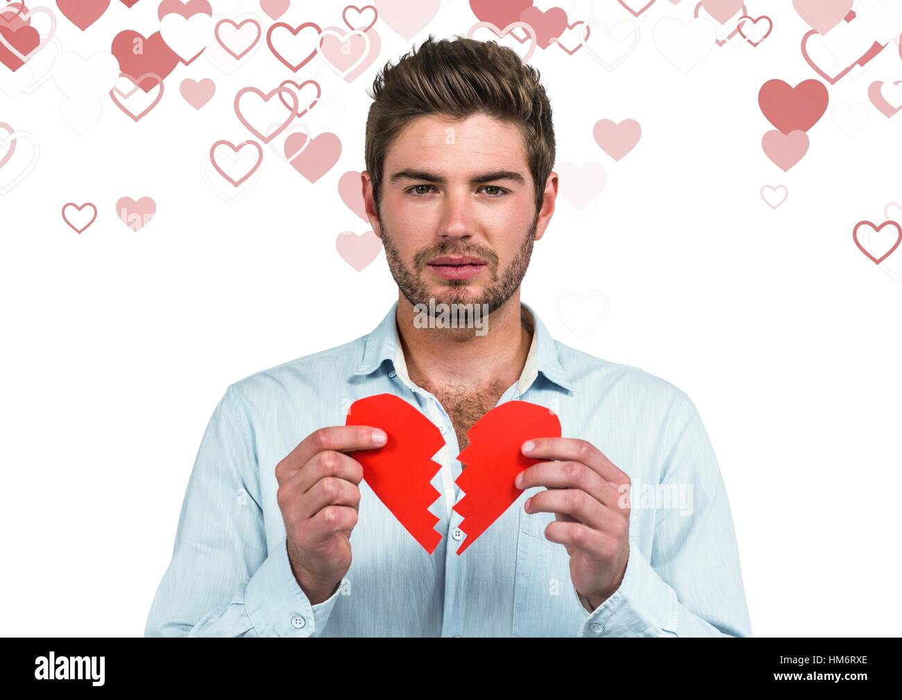 Depressed man holding broken heart Stock Photo - Alamy