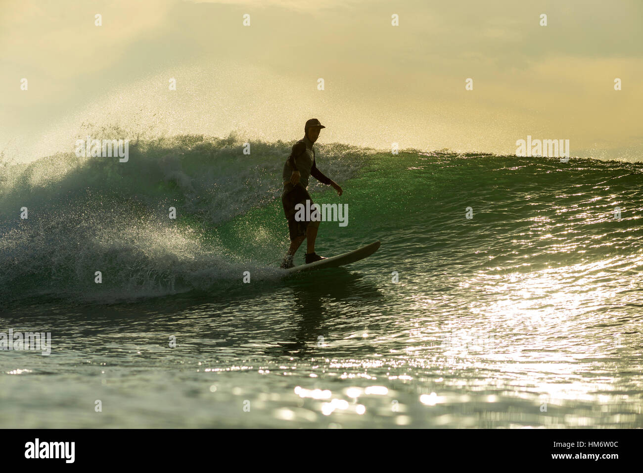 Side view of silhouette man surfing in sea during sunset Stock Photo ...
