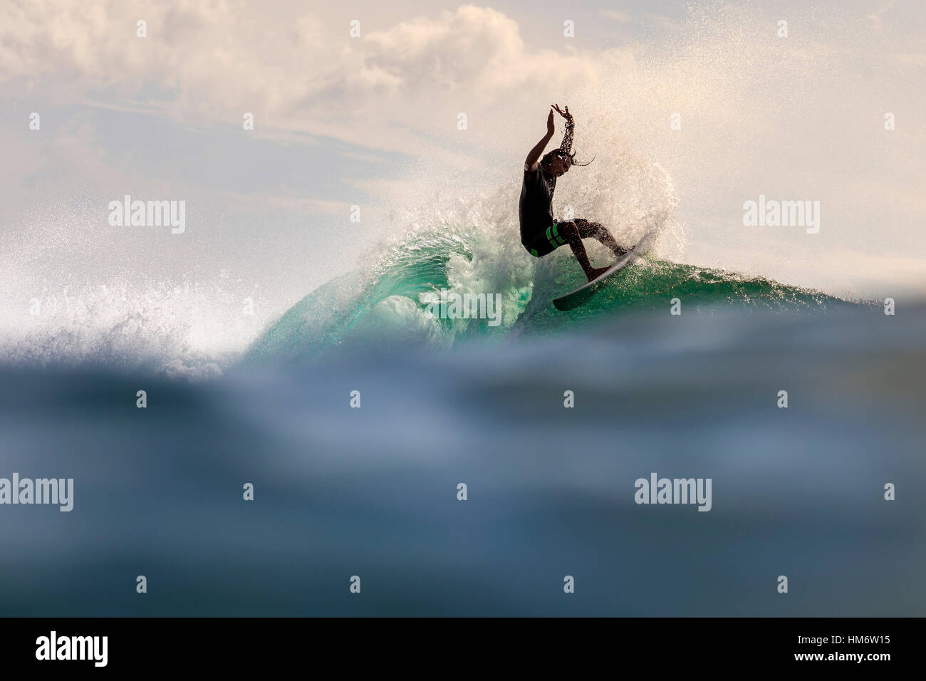 Young man surfing in bali hi-res stock photography and images - Alamy