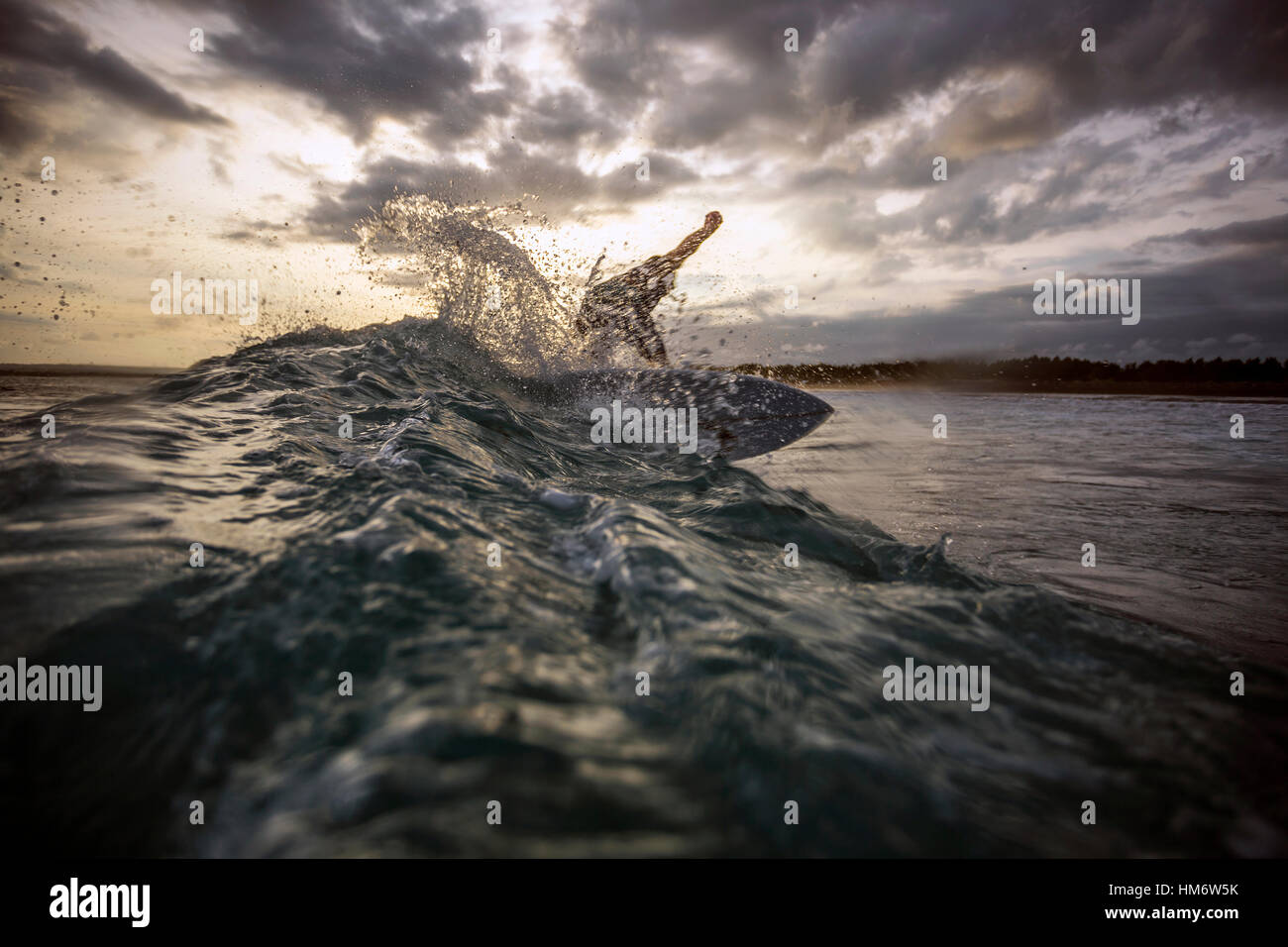 Man performing stunt while surfboarding in sea Stock Photo - Alamy