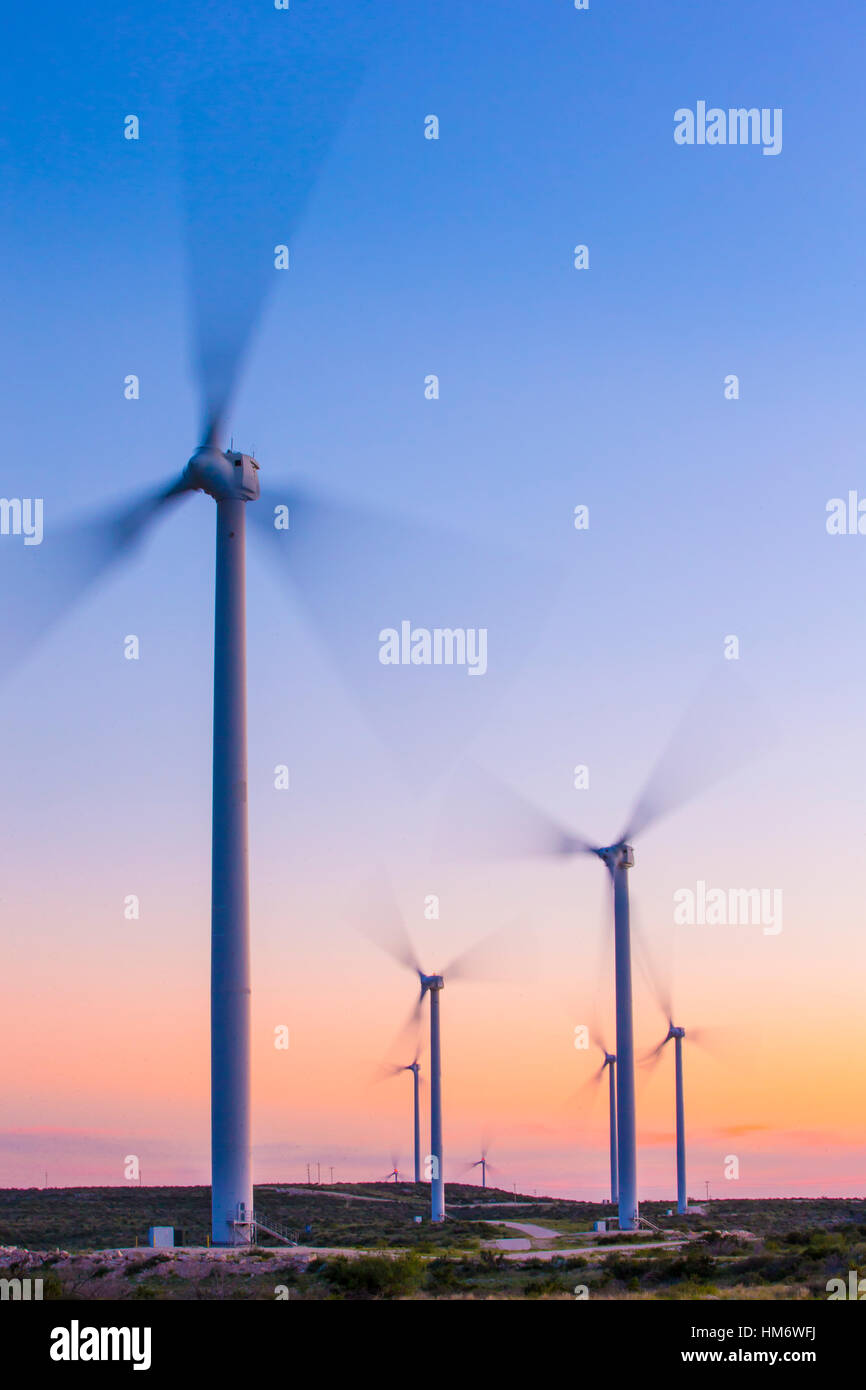 Wind turbines spinning during sunset Stock Photo - Alamy