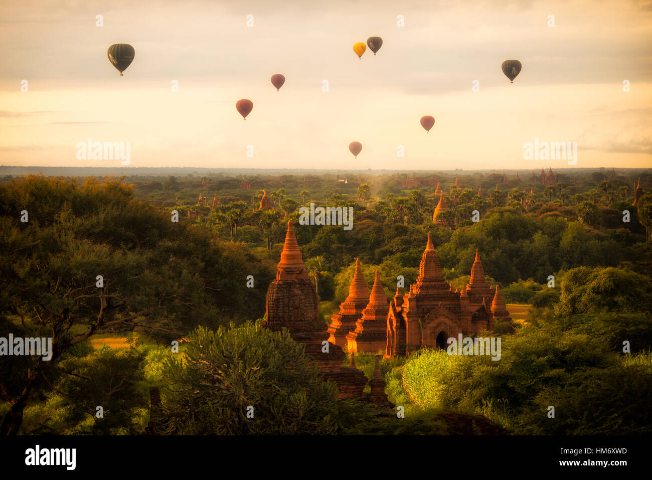 BAGAN, Myanmar — Hot air balloons float over the misty plain of Bagan ...