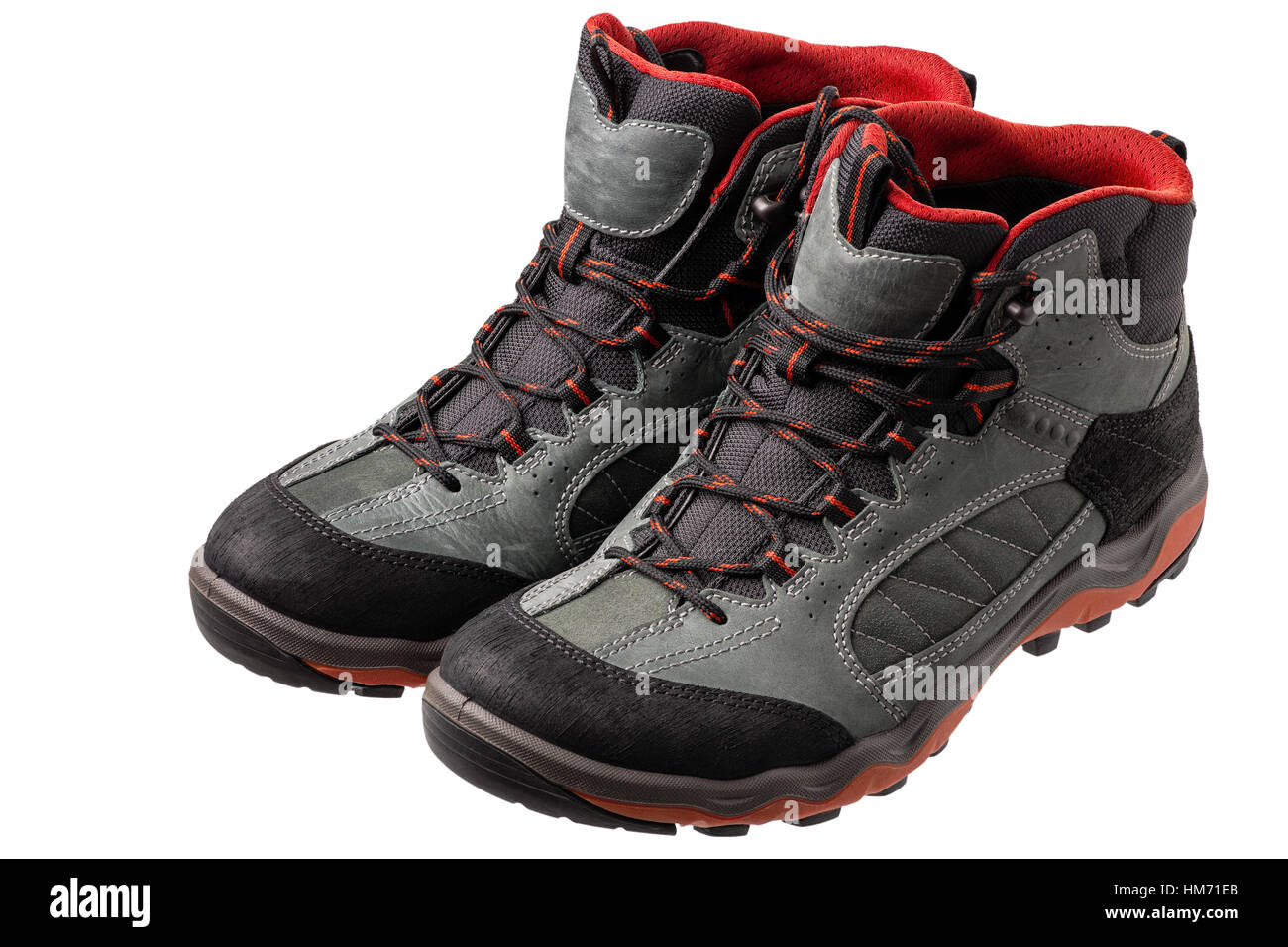 Pair of tracking boots of gray color with red inserts on a white ...