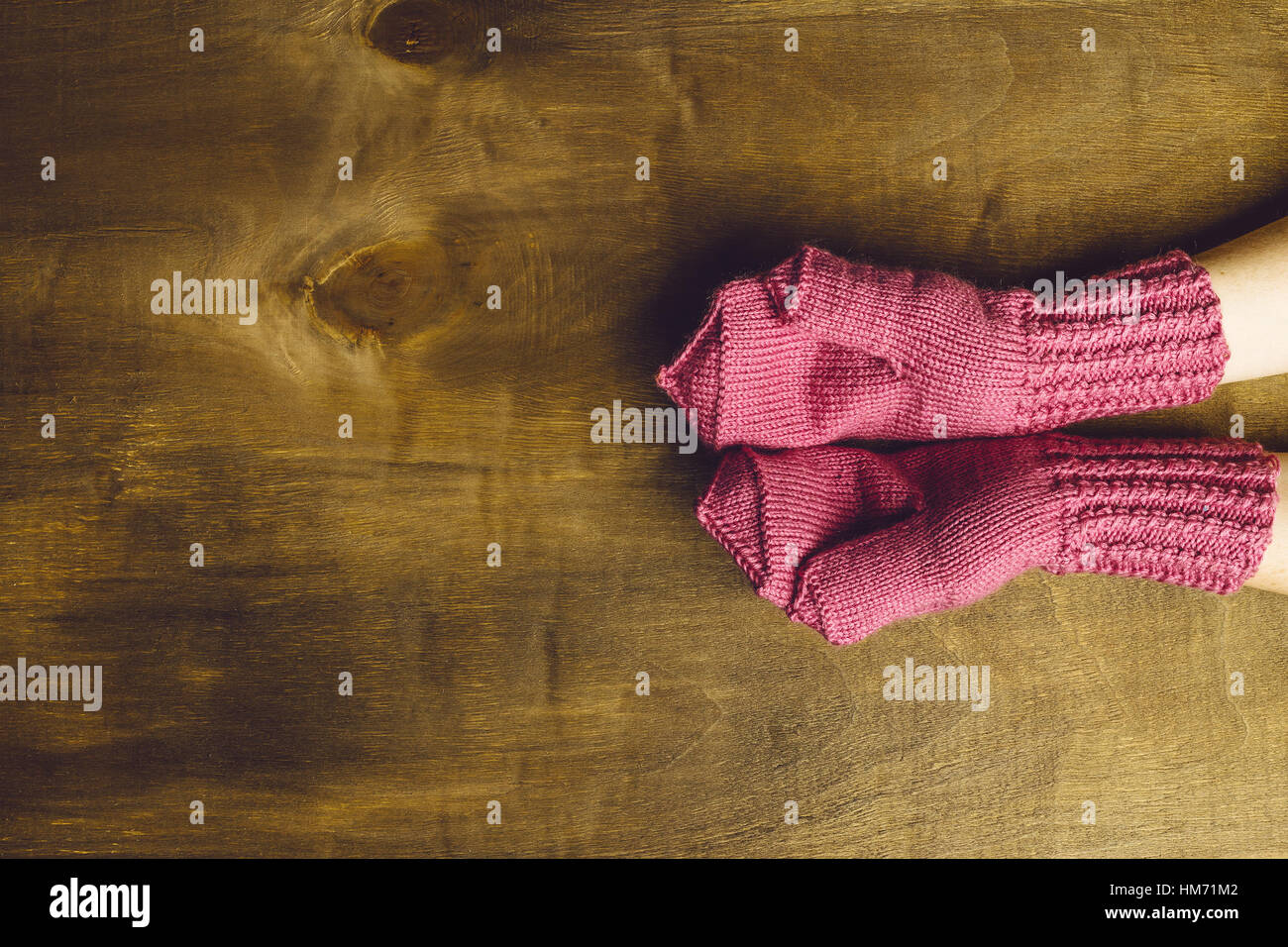 The opened girl's palms dressed in pink mittens. Hands are located over ...