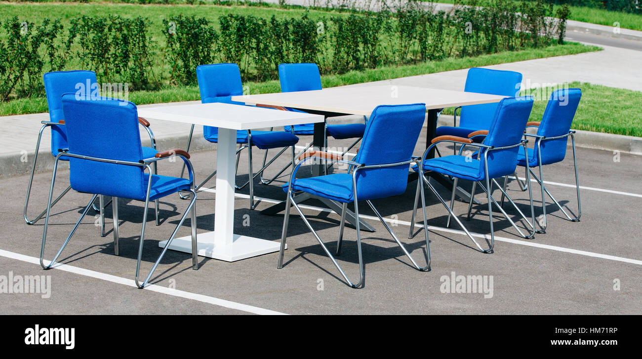 Table for business meetings and chairs are standing on street parking ...