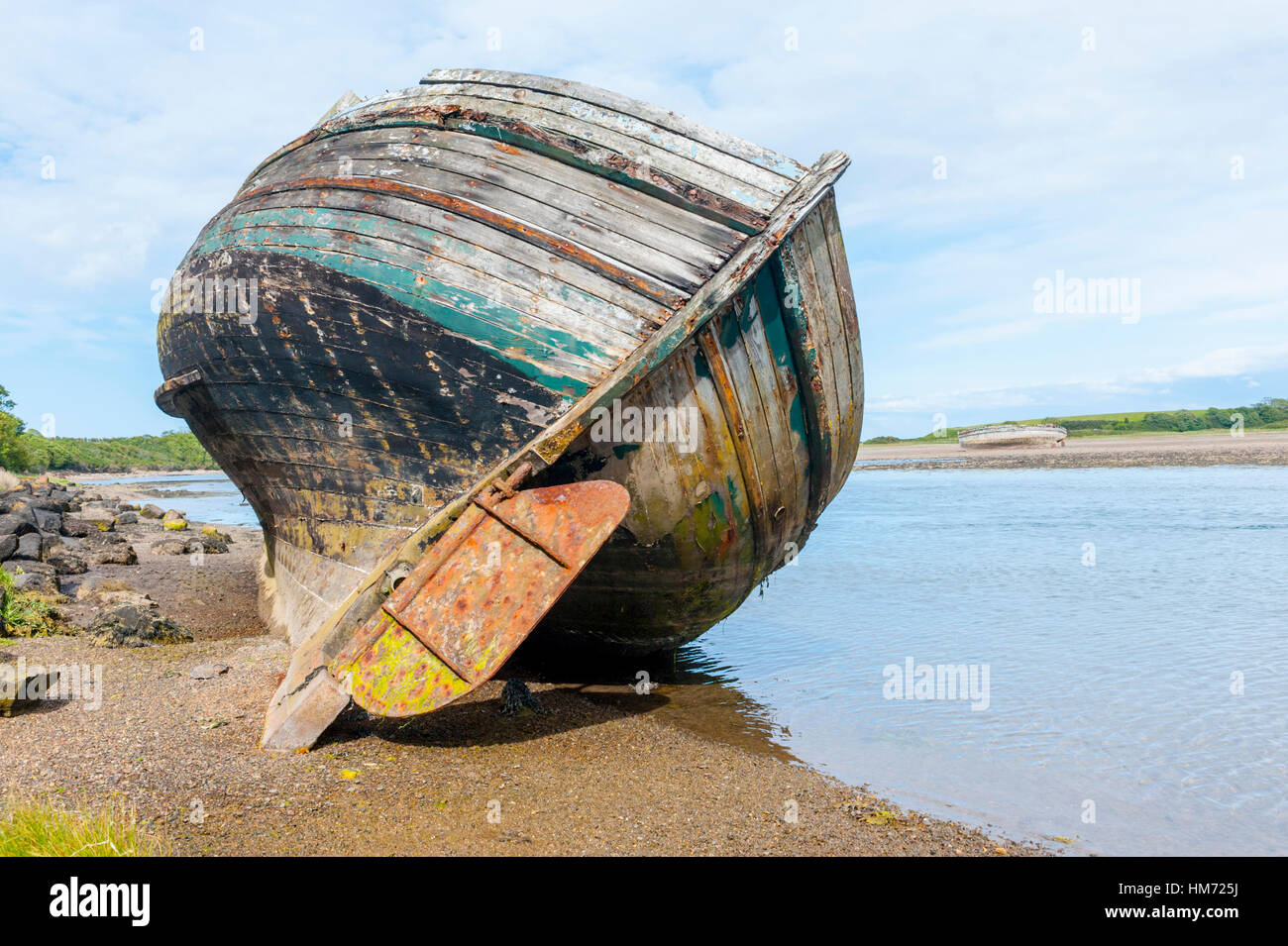 Wrecked boats aground on mud banks at Treath Dulas, Anglesey, Wales ...