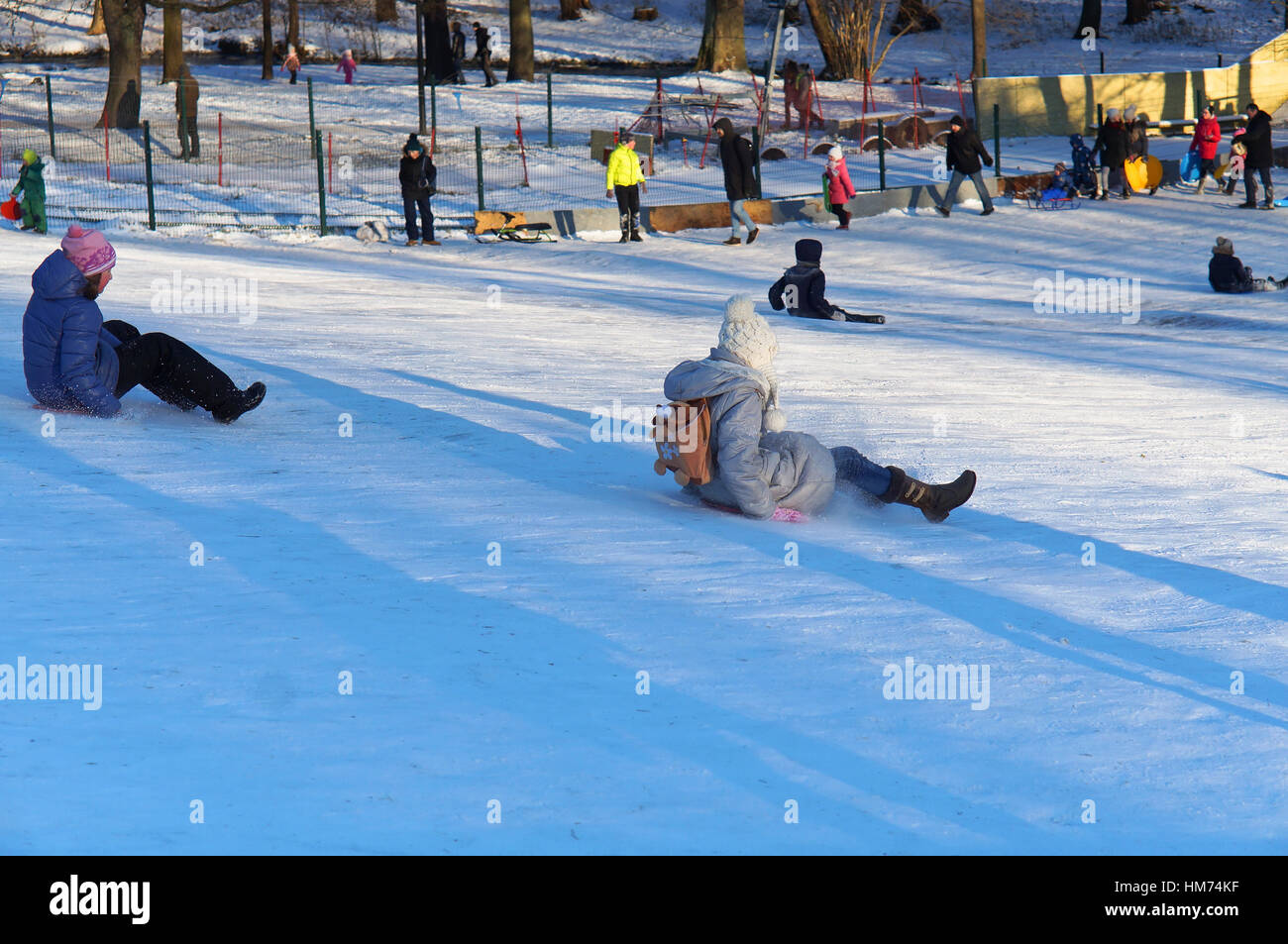 children love the winter sledding downhill fun Stock Photo - Alamy