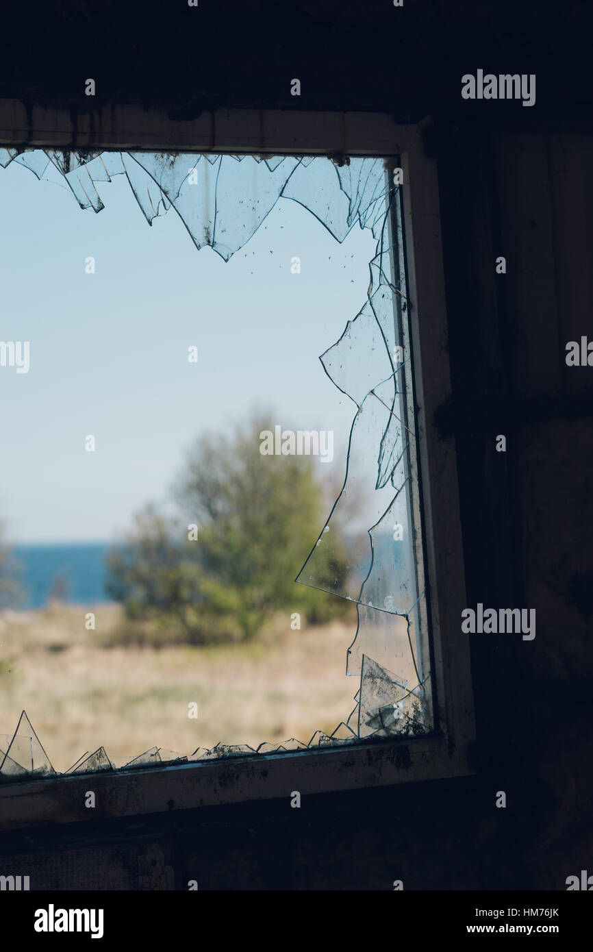 View through window with broken glass. Decay concept Stock Photo - Alamy