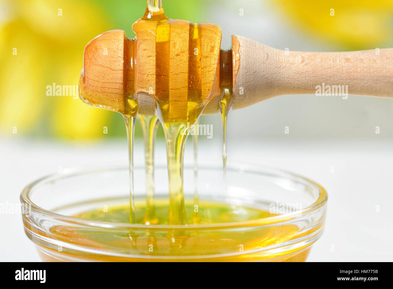 Golden honey dripping from dipper Stock Photo - Alamy