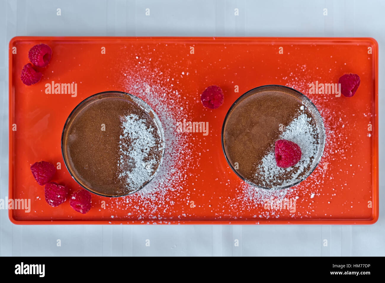 Homemade chocolate mousse with fresh raspberries on a table, top view ...