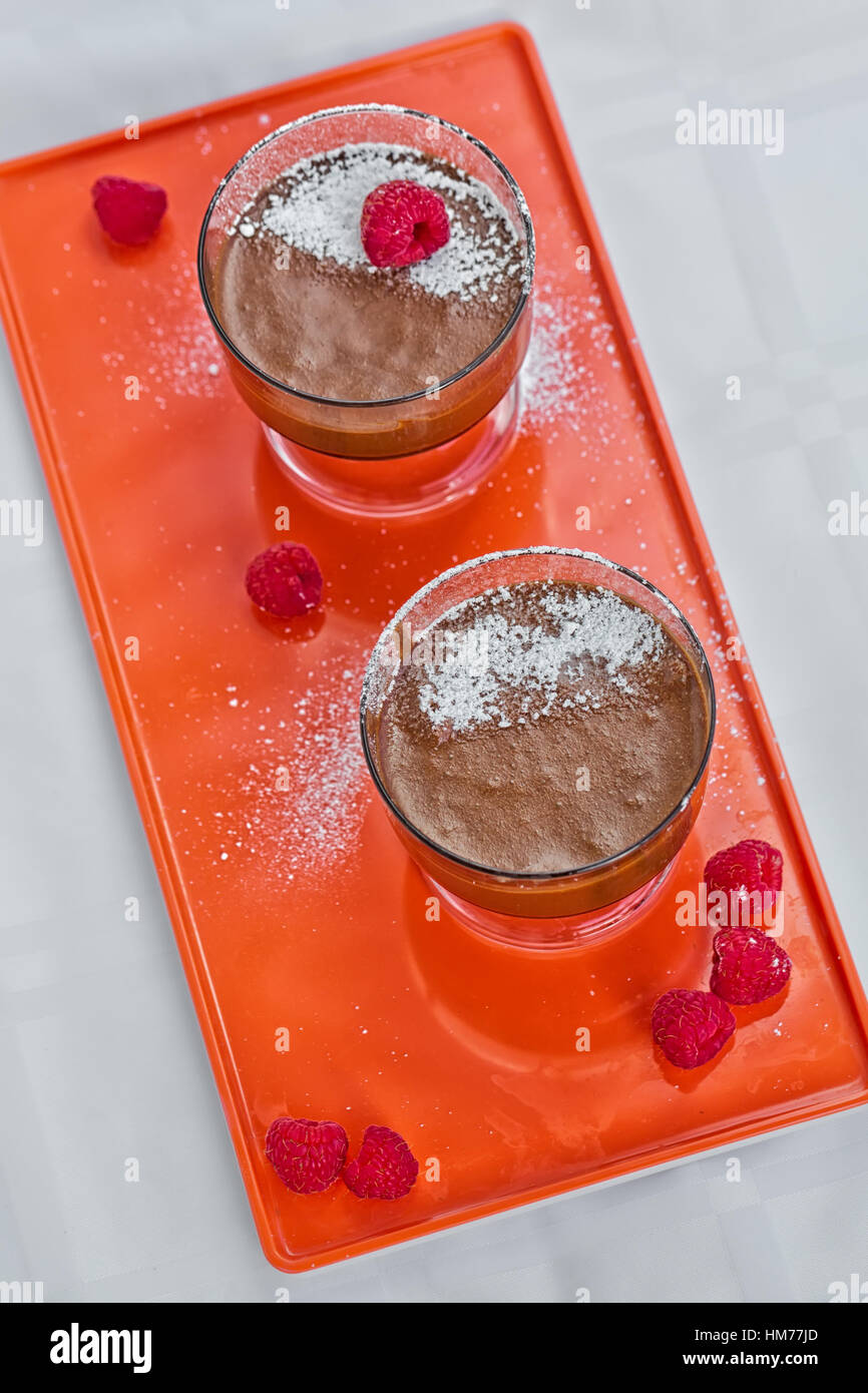 Homemade chocolate mousse with fresh raspberries on a table, top view ...