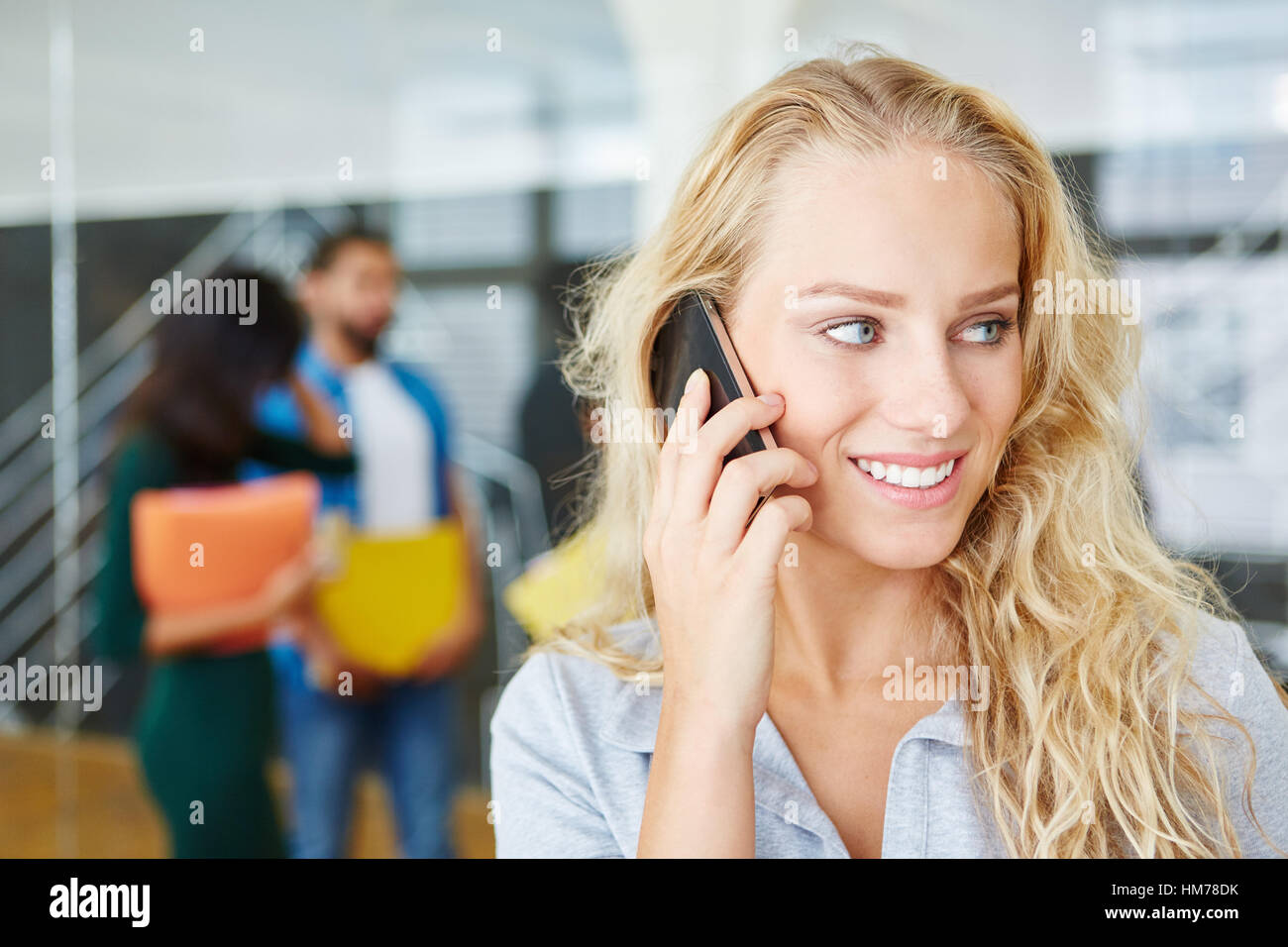 Business woman making a call in start-up Stock Photo - Alamy