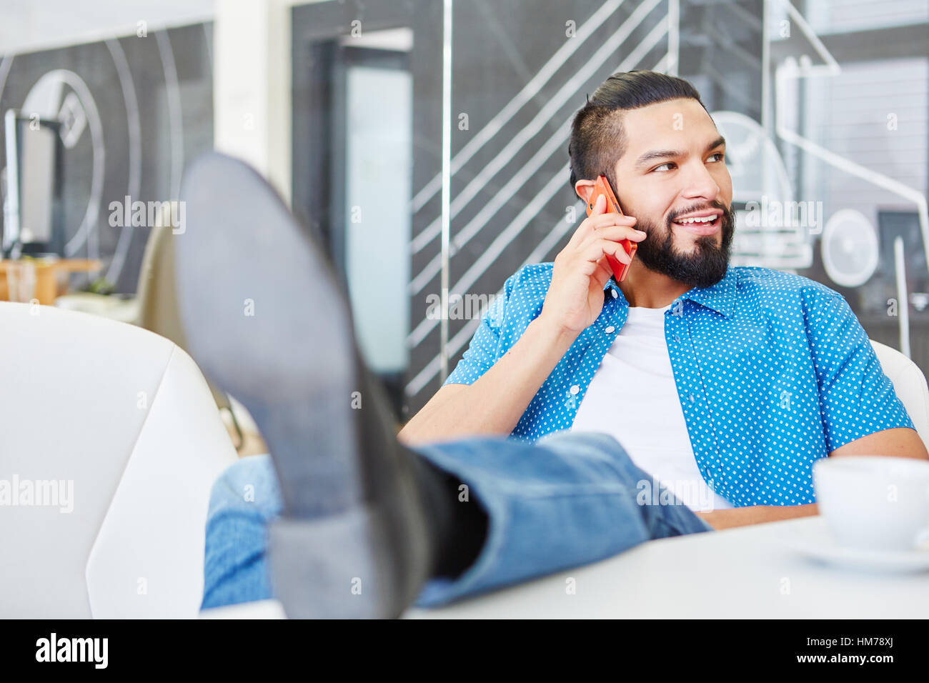 Young man with mobile phone as start-up founder Stock Photo - Alamy