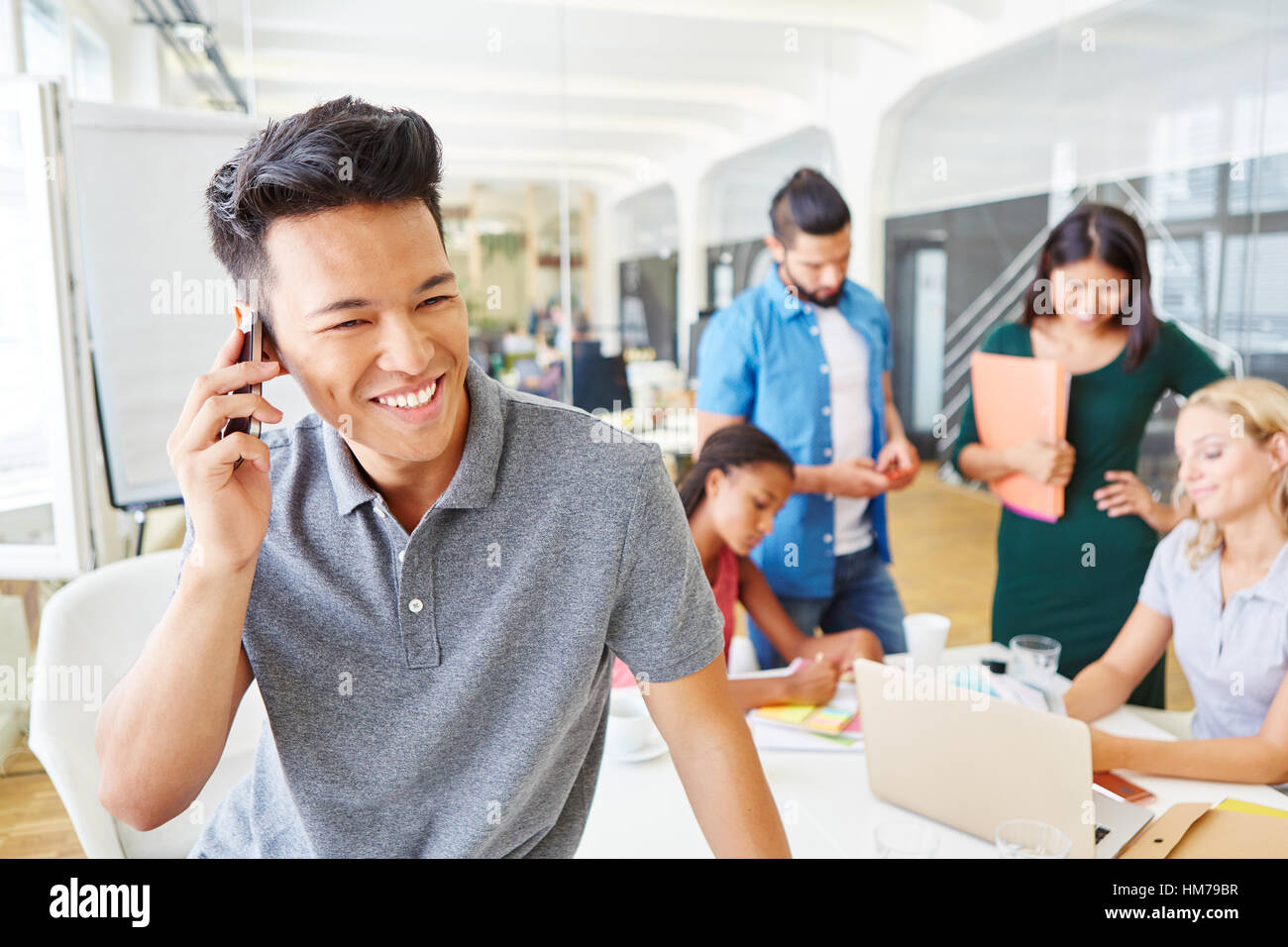 Student in meeting making a call with smartphone Stock Photo - Alamy
