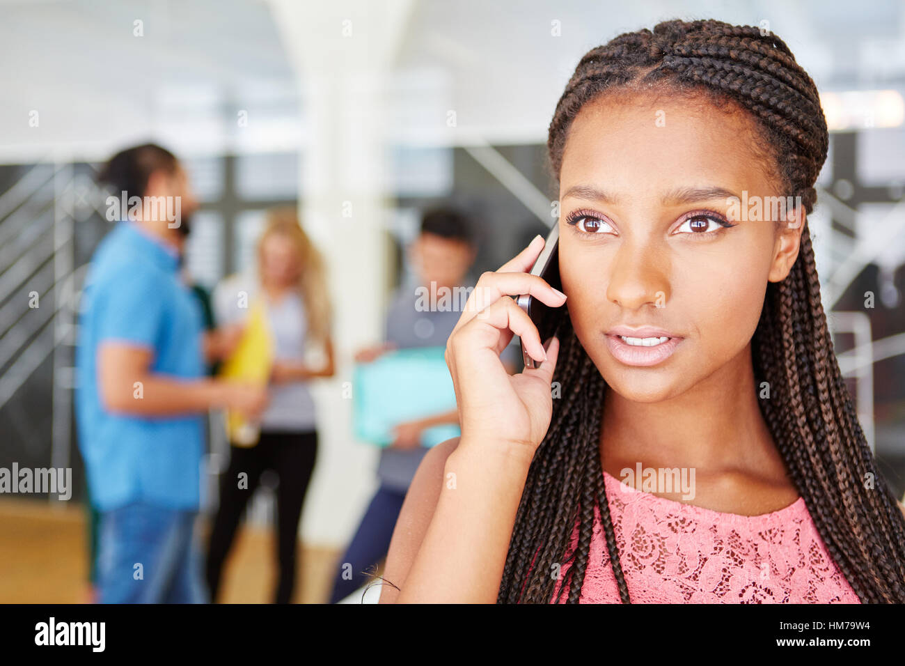 Young woman calling the servicing line at start-up company Stock Photo ...