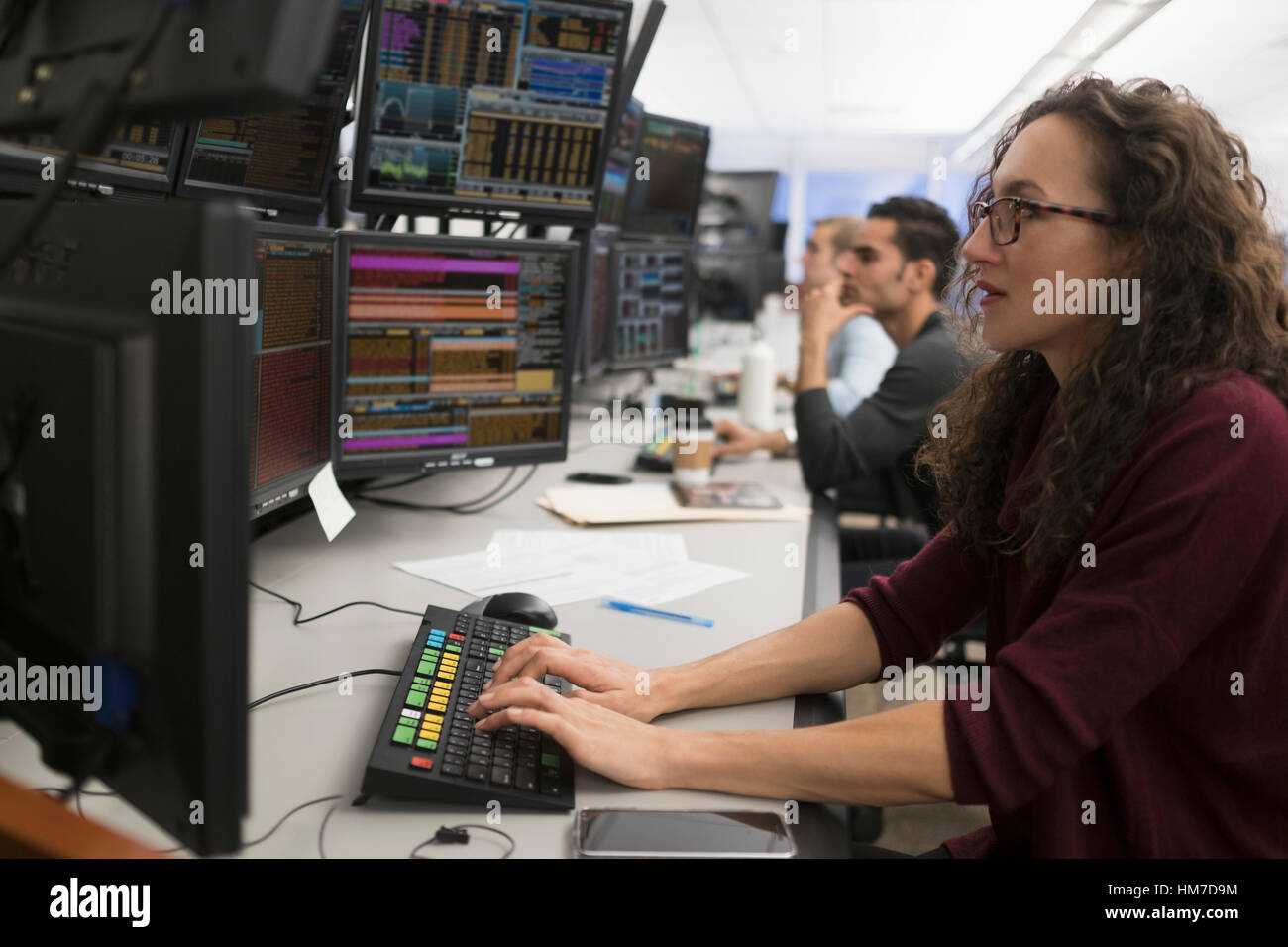 Young traders analyzing computer data Stock Photo - Alamy