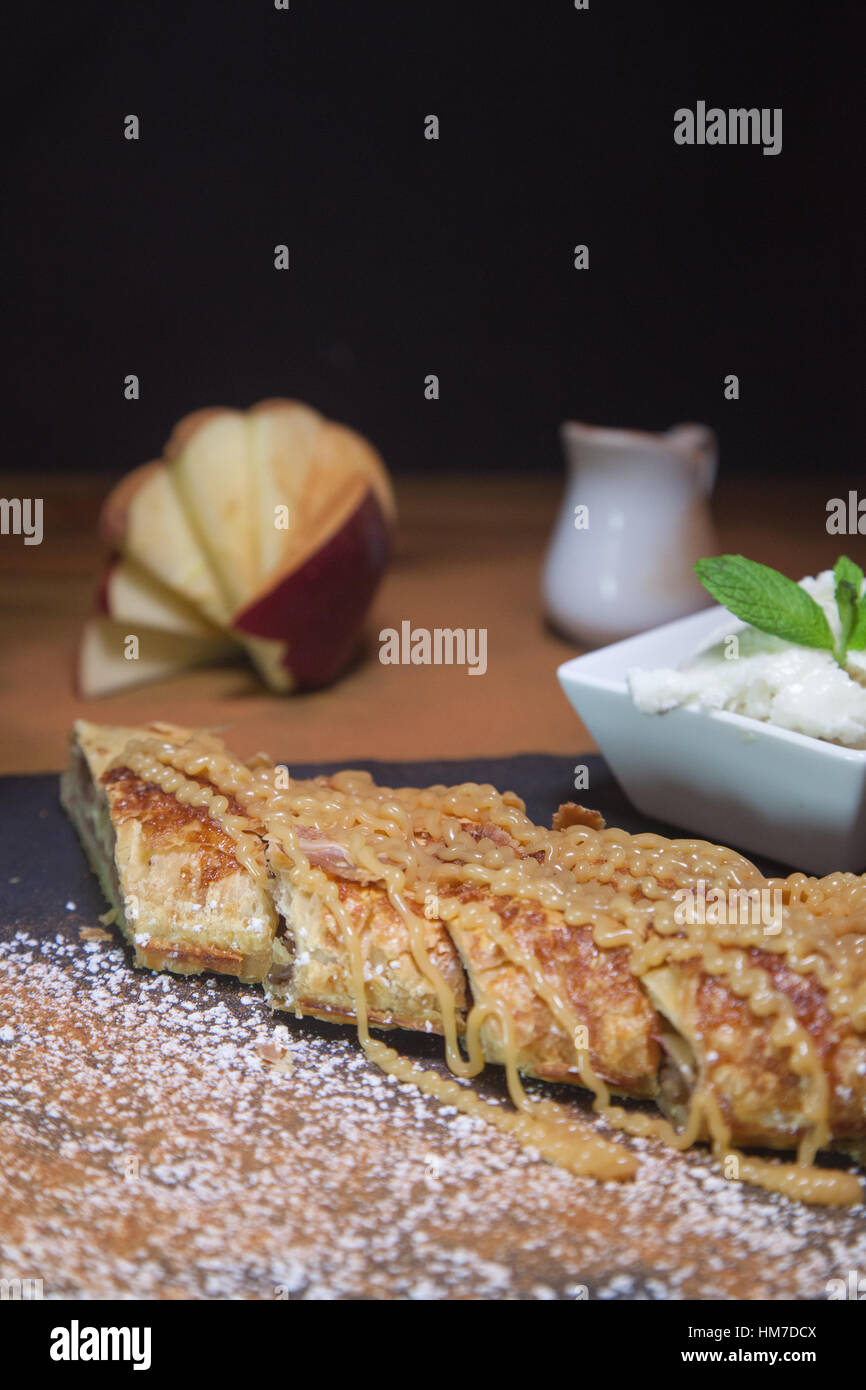 Apple strudel with ice cream black background Stock Photo - Alamy