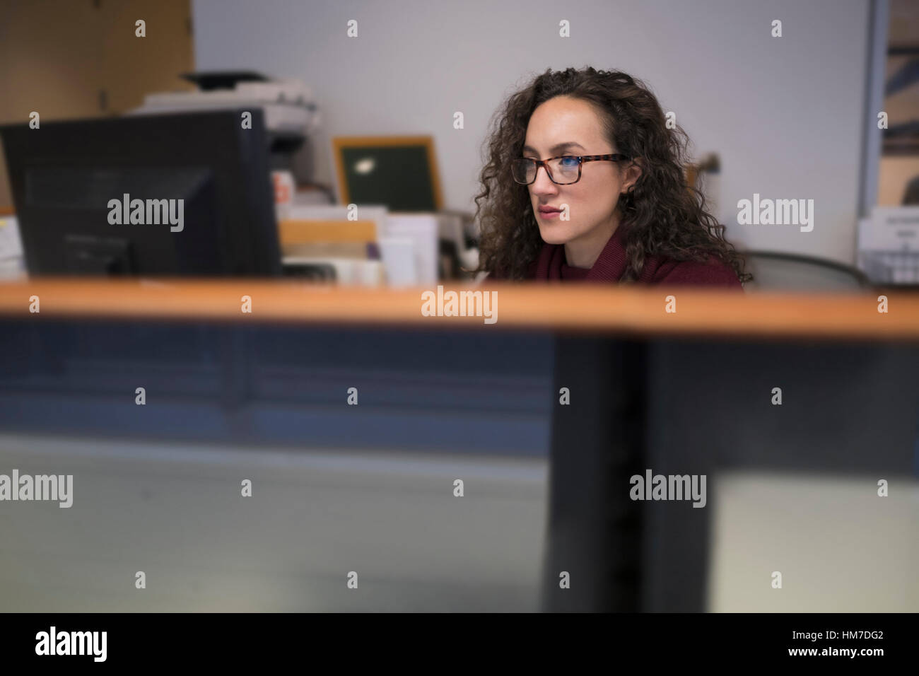 Young woman looking at computer monitor Stock Photo - Alamy