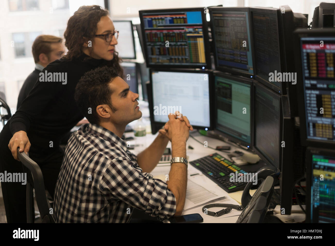 Young traders analyzing computer data Stock Photo - Alamy