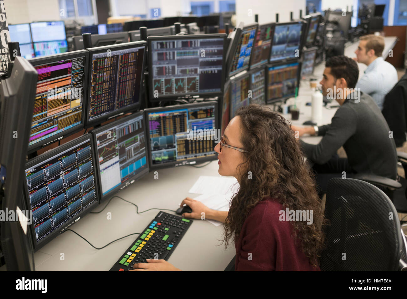 Young traders analyzing computer data Stock Photo - Alamy
