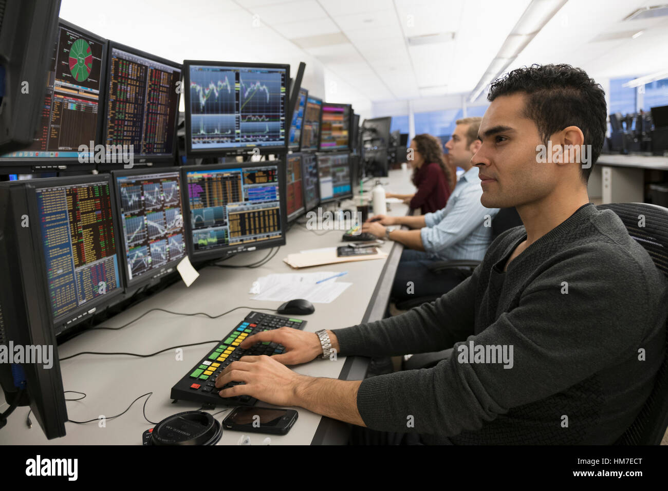 Young traders analyzing computer data Stock Photo - Alamy