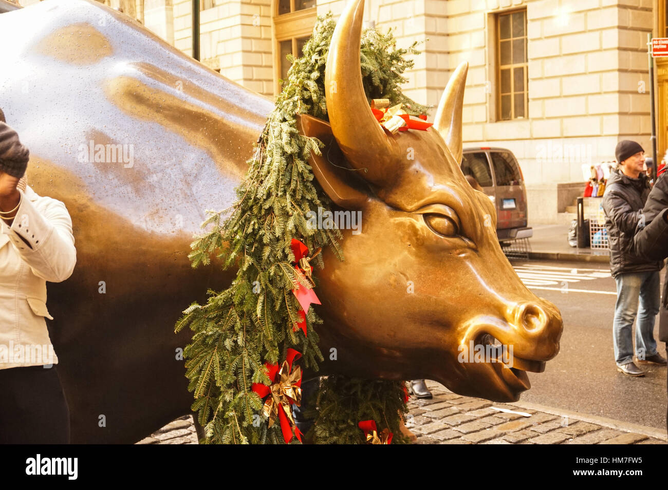 Tourists taking photos with the Charging Bull sculpture in a Christmas ...