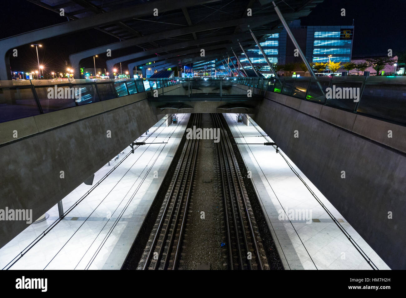 Looking down on railway tracks running between concrete platforms at a ...