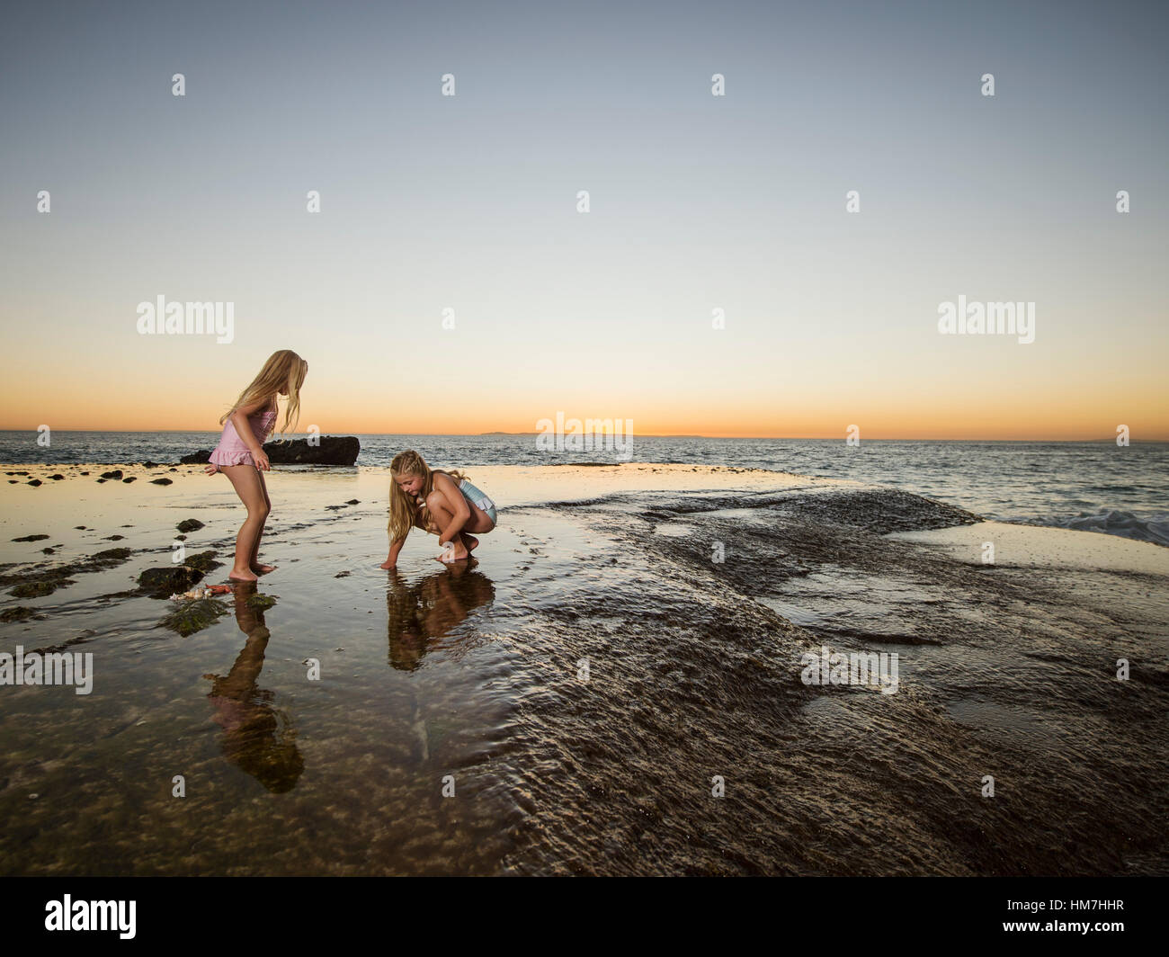 Girls (6-7,8-9) playing on beach Stock Photo - Alamy