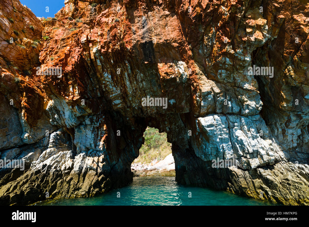 Wave motion erosion in a sandstone cliff forms a cave Stock Photo - Alamy