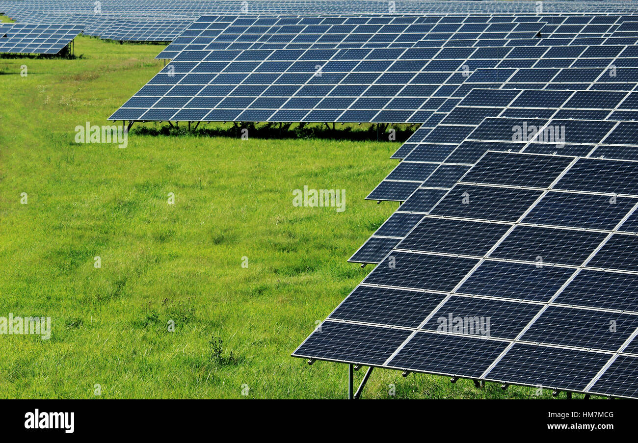 huge power solar plant on the green field Stock Photo - Alamy