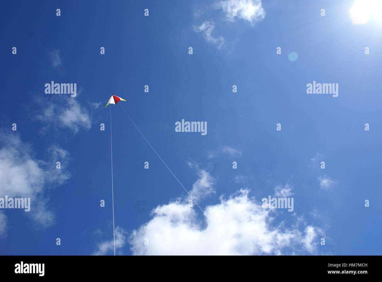 Colourful kite flying in the blue summer sky Stock Photo - Alamy