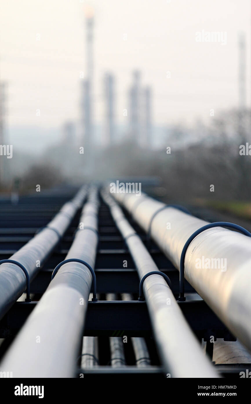 crude oil pipeline and oil refinery against light Stock Photo - Alamy
