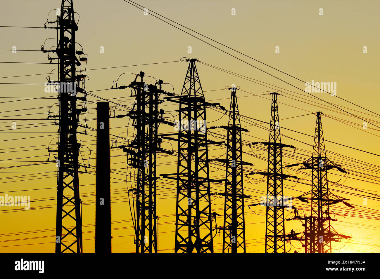 different high voltage pylons on yellow background Stock Photo - Alamy