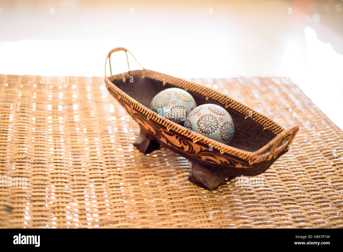 Ball in a wooden bowl on top of rattan center table Stock Photo - Alamy