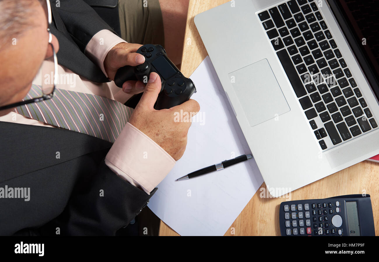 business man play games on working desk Stock Photo - Alamy