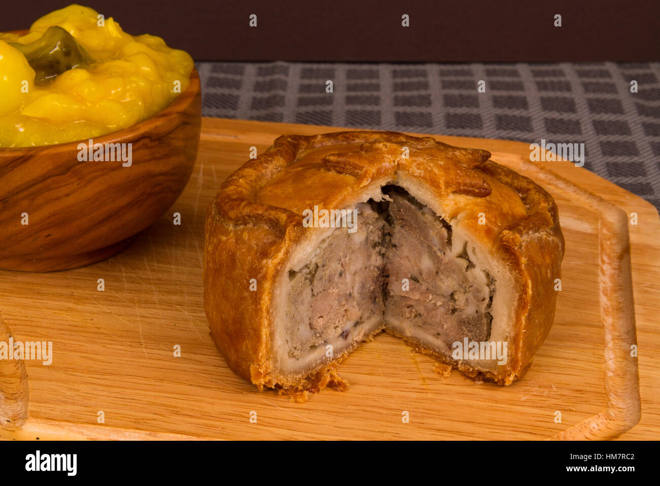 Piccalilli relish in a wooden bowl on a board Stock Photo - Alamy