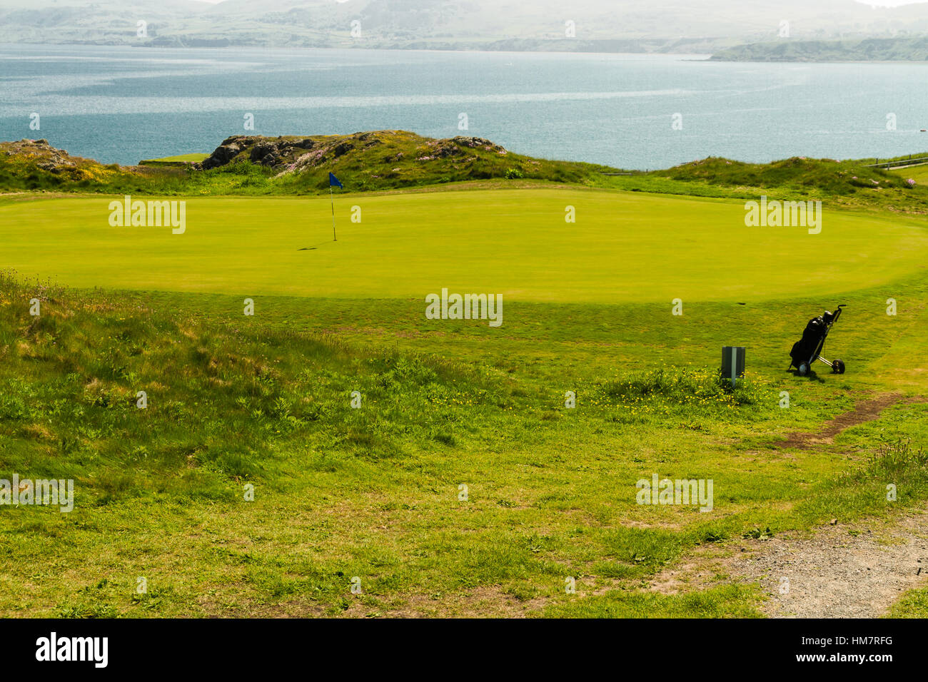 Clifftop putting green with bag and sea, Nefyn & District Golf Club ...