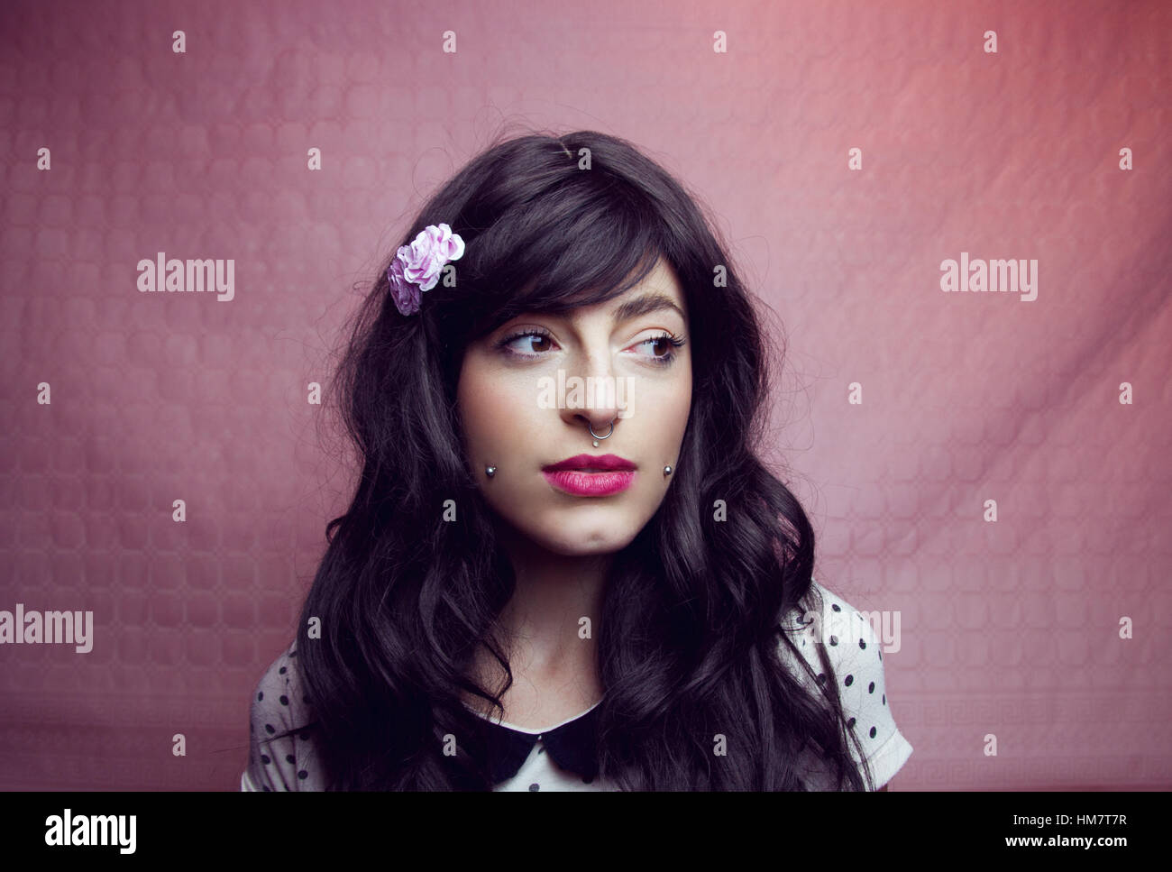 Portrait of a pretty young woman with pink background Stock Photo - Alamy